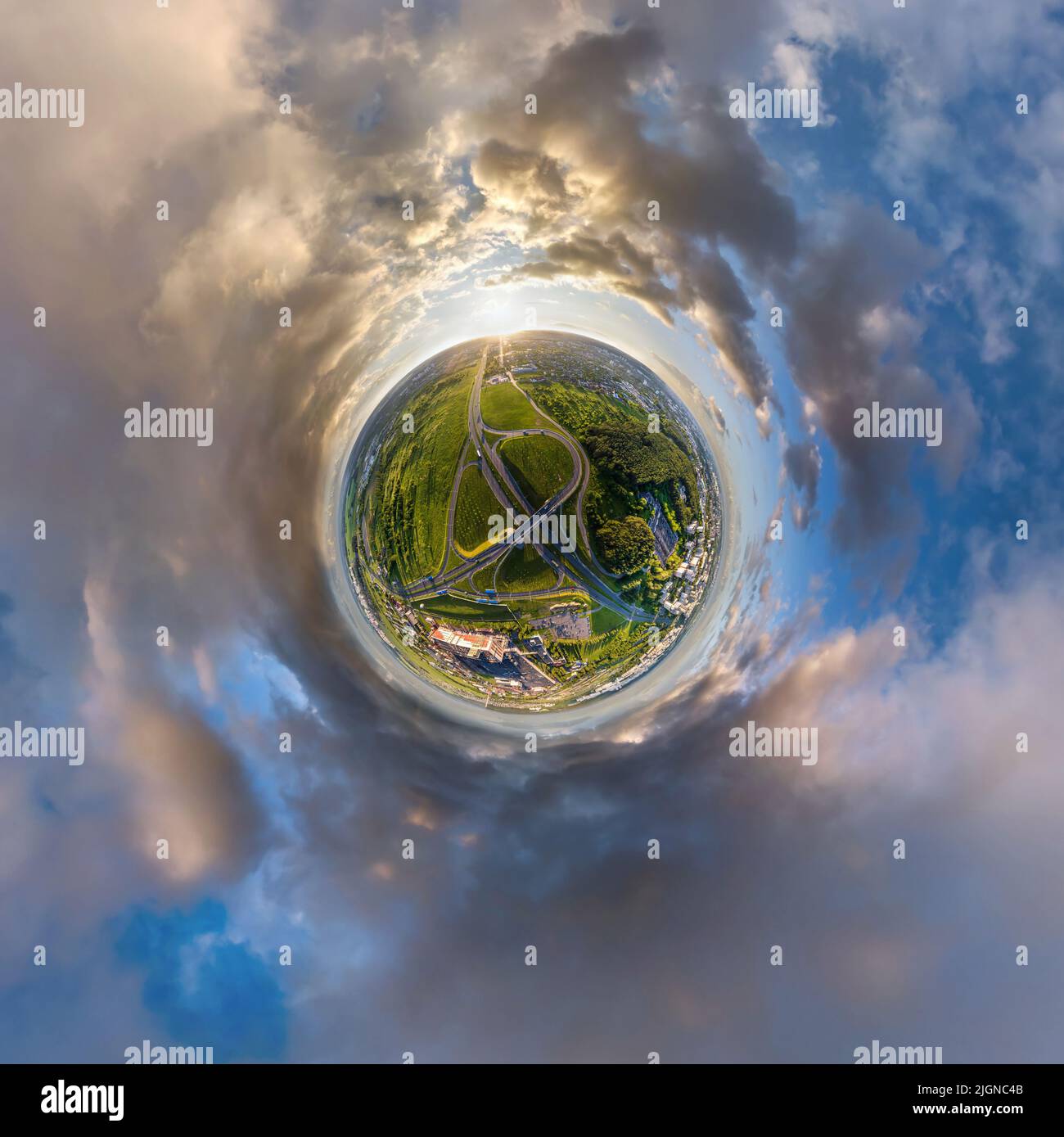 tiny planet in sky with clouds overlooking old town, urban development ...
