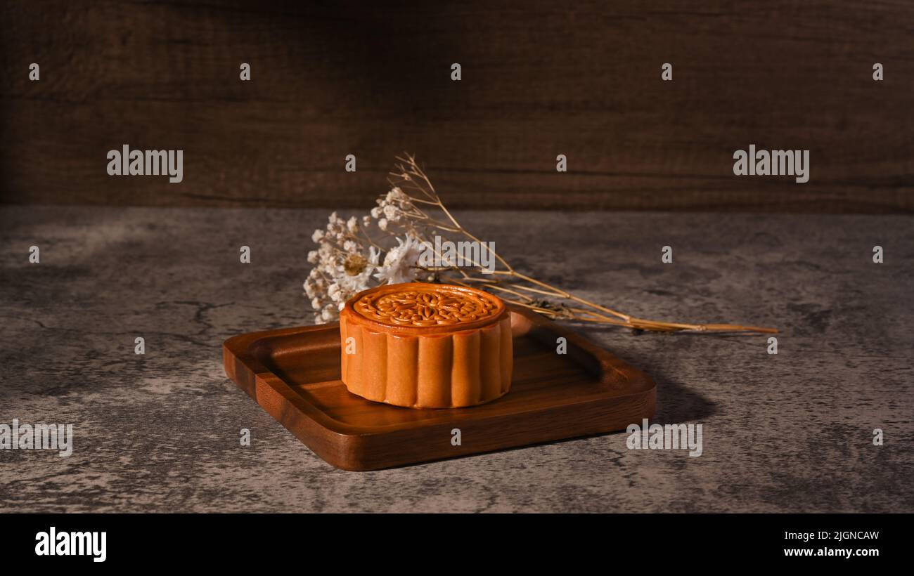 Traditional Chinese mooncakes with tea and decorating with dried flower ...