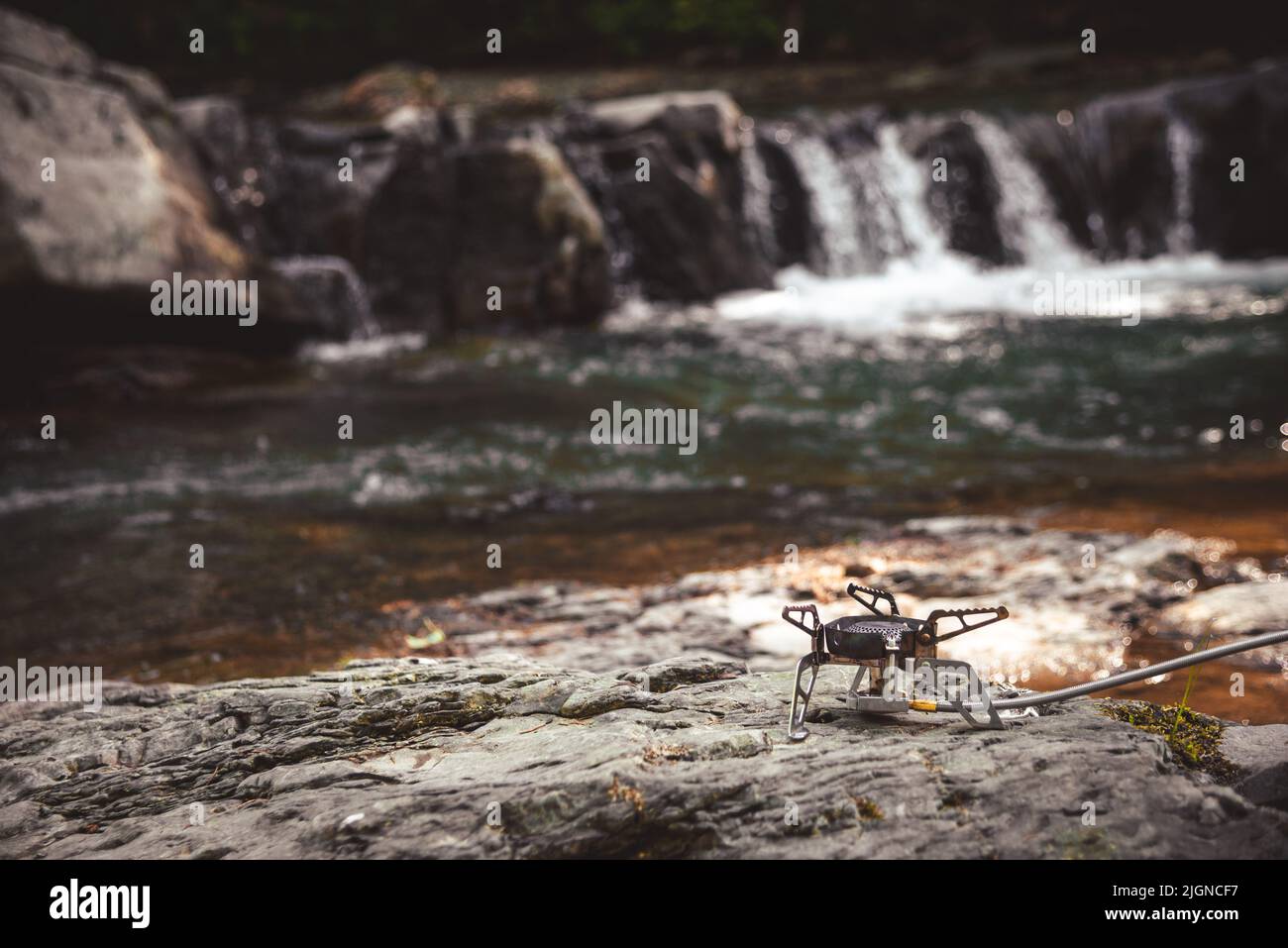 Cooking food using camping gas during the hike Stock Photo - Alamy
