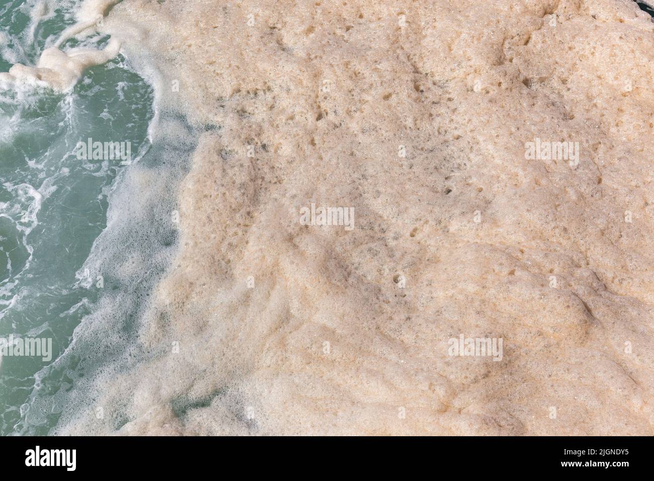 Ocean sea water foam from large waves crashing breaking wash and ...