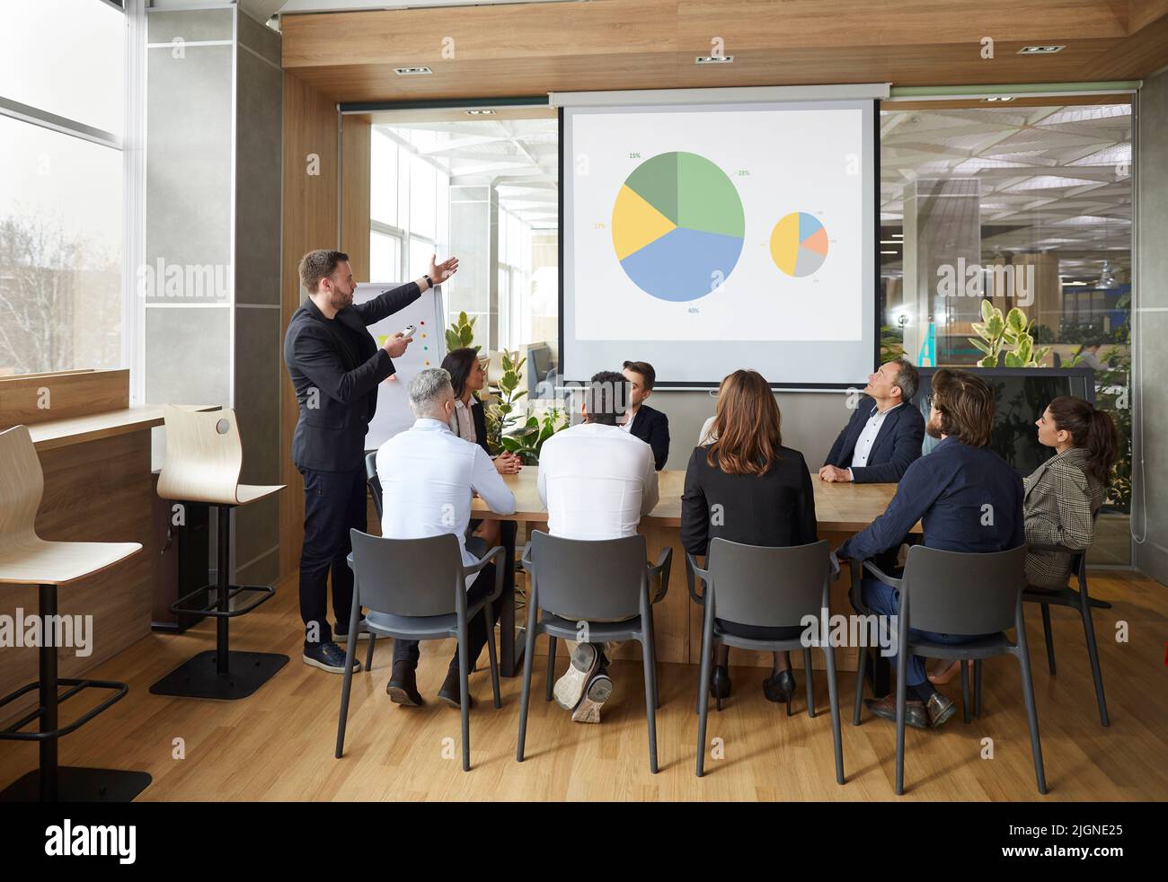 Manager shows his colleagues business presentation with data analysis ...