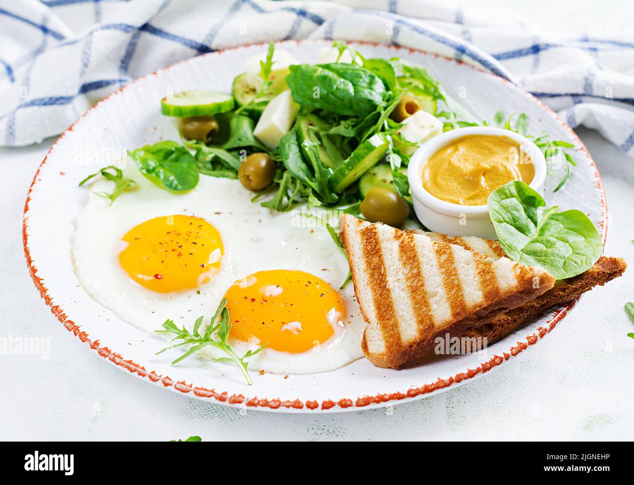 English breakfast - fried eggs, cheese, cucumber, olives and spinach ...