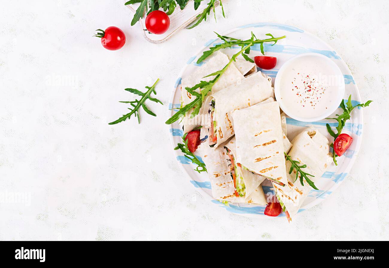 Burritos wraps with beef and vegetables on light background. Beef ...