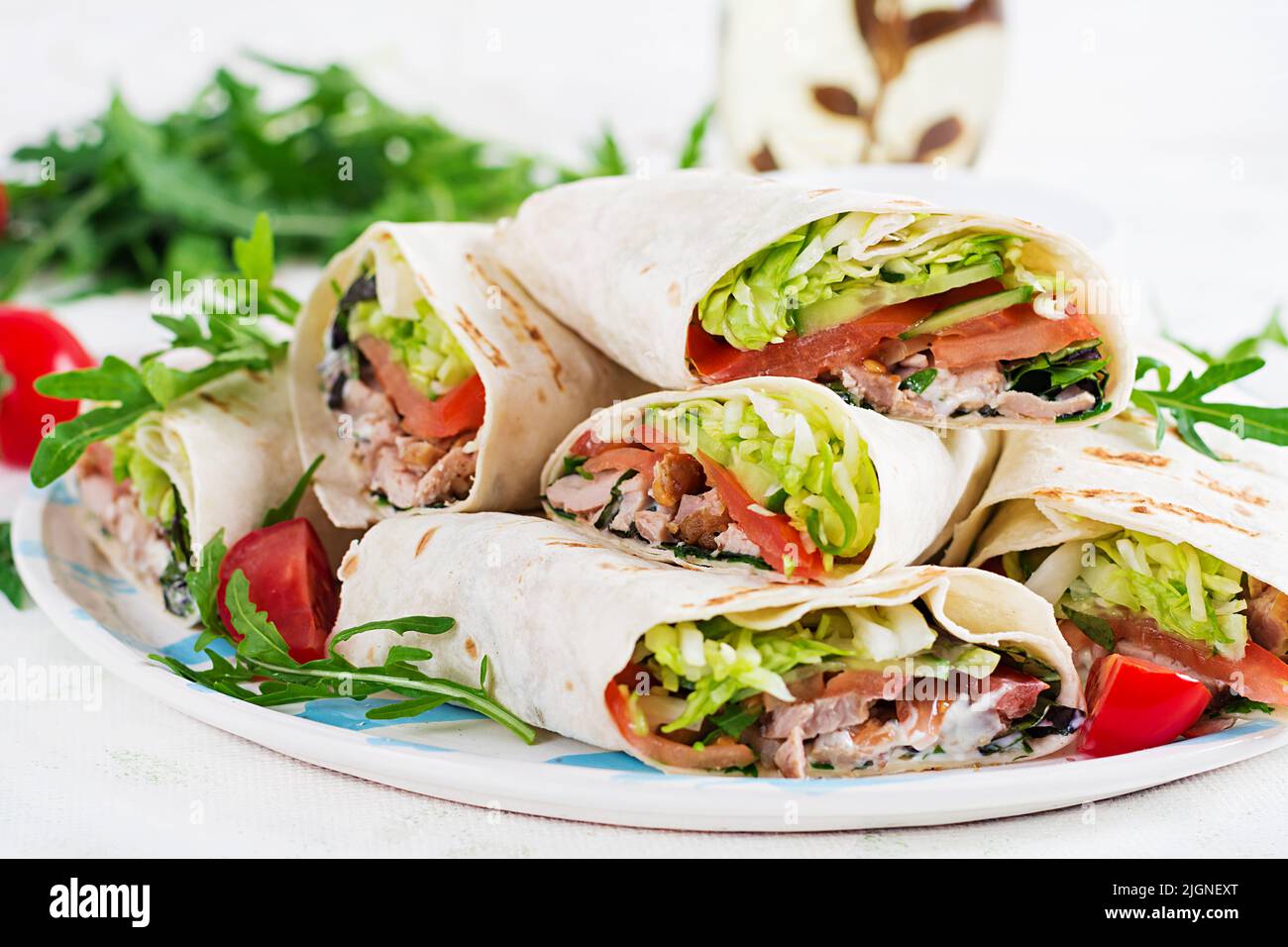 Burritos wraps with beef and vegetables on light background. Beef ...