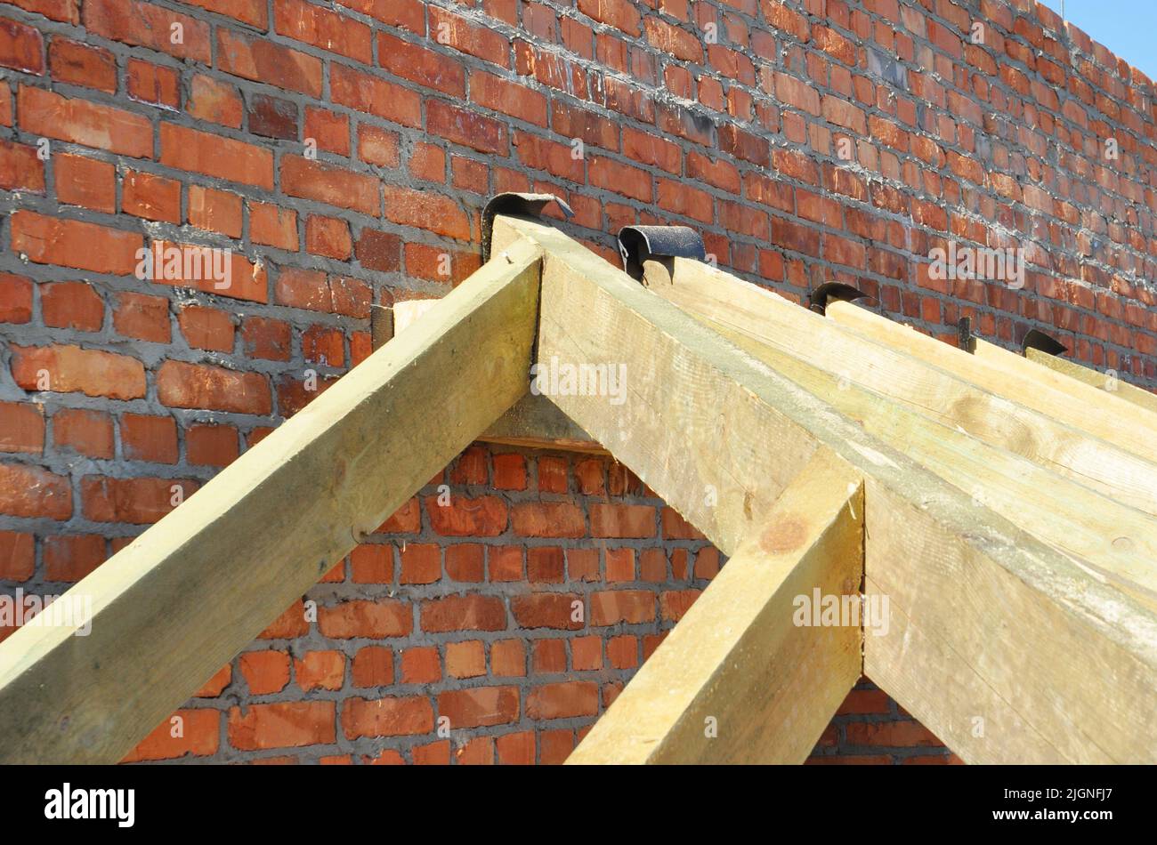 Close up on house roof trusses, rafters, wooden beams connection with ...