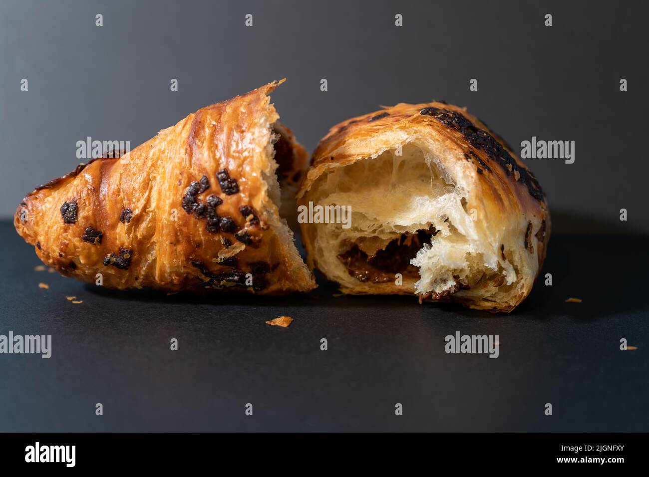 Half Croissant Black background Stock Photo - Alamy
