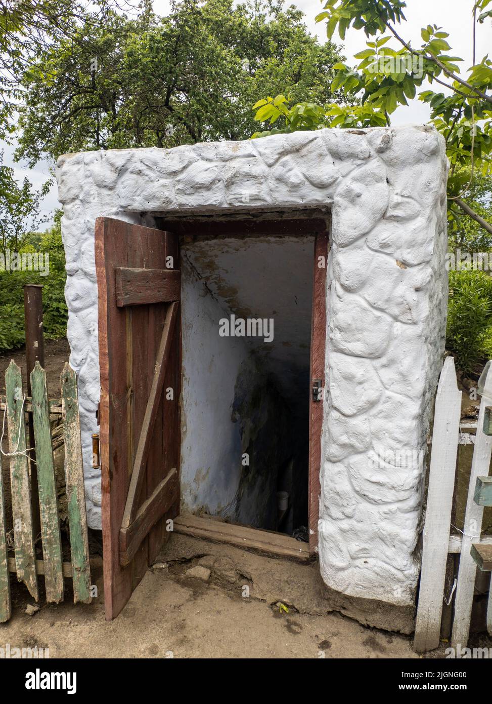 Open door historic vintage root cellar dug underground in the ...