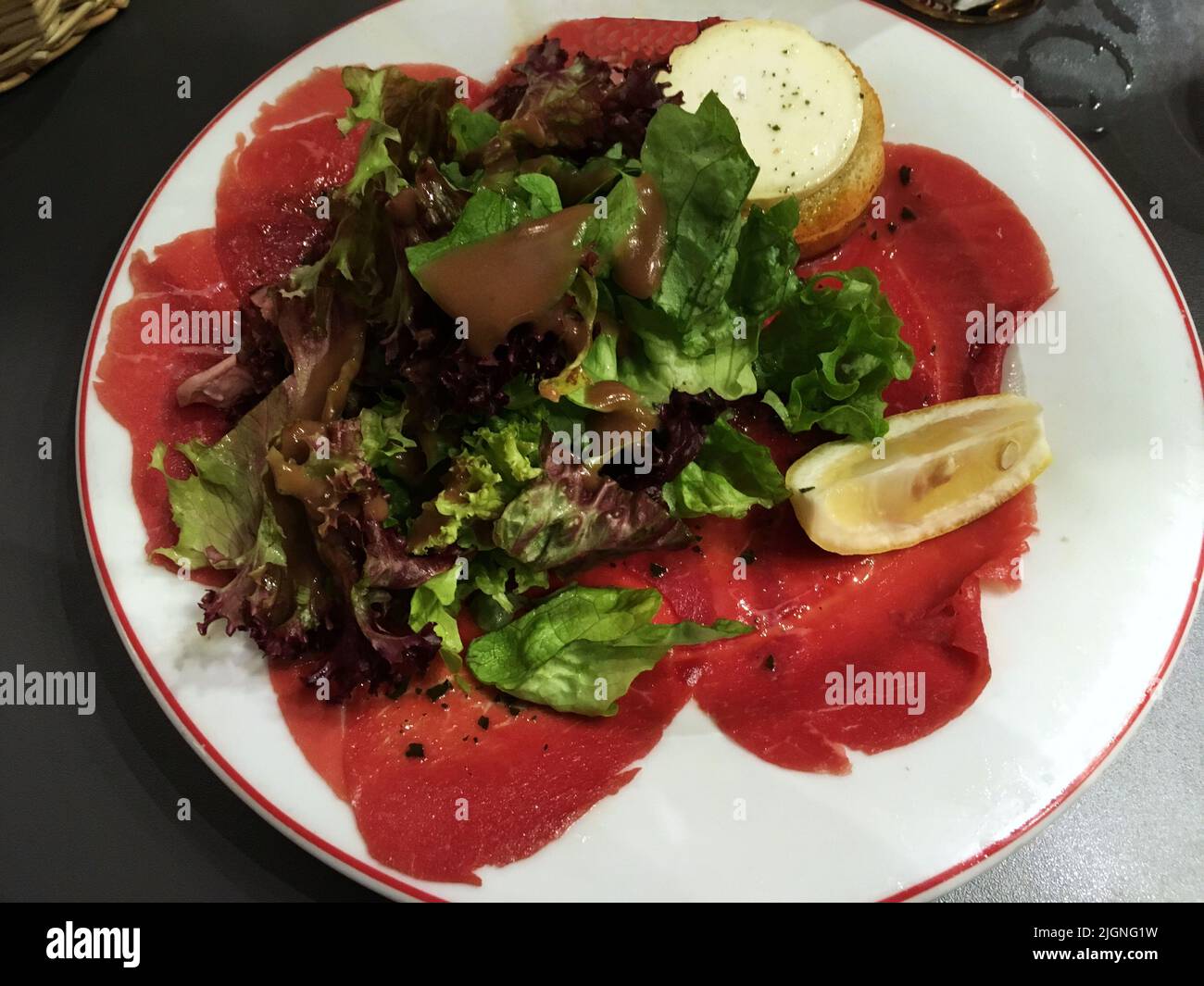 Thinly sliced and served raw, typically as an appetizer. The beef was ...