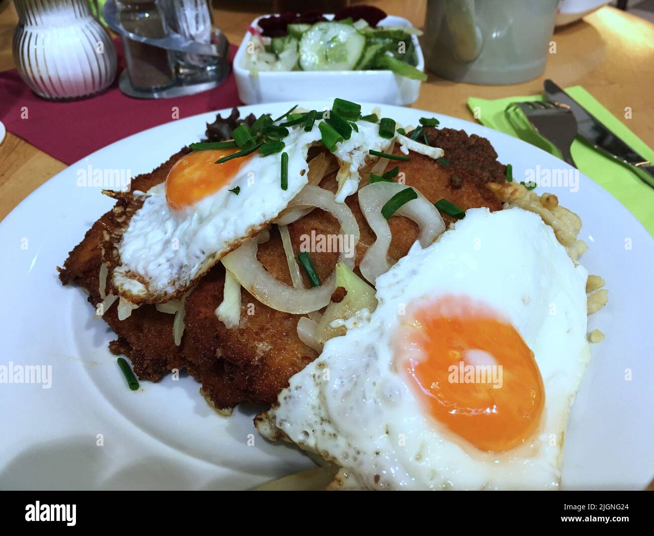 Schnitzel, german or wiener, top with sunny side up eggs and baked ...