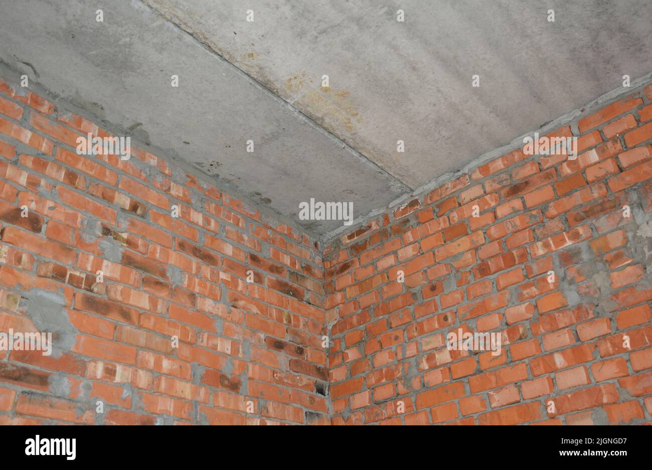 Close up on brick house monolithic concrete ceiling construction indoor ...