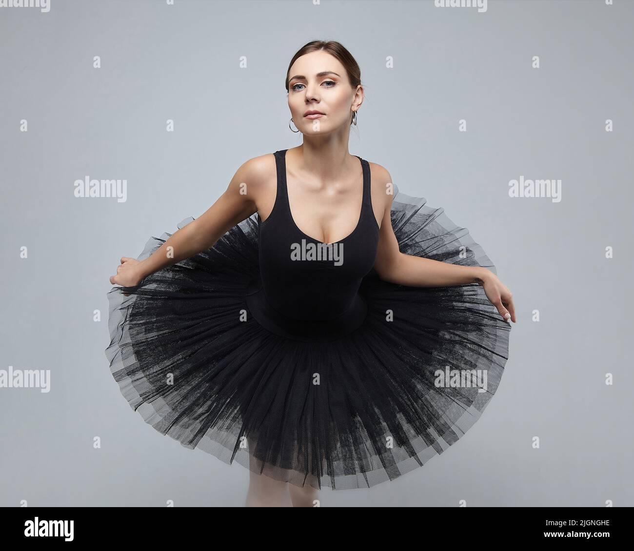 portrait of attractive ballerina. photo shoot in the studio on a white ...