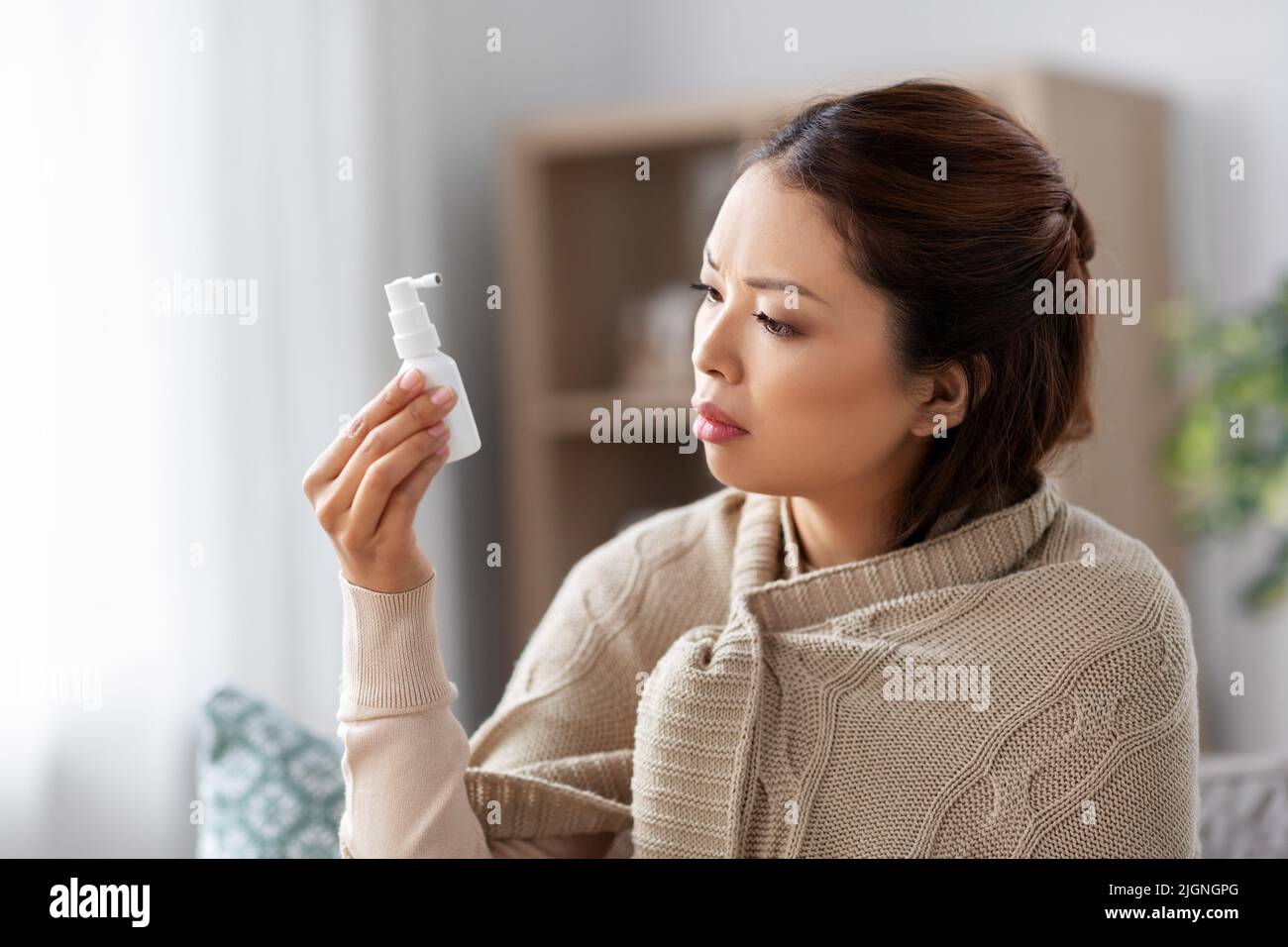 sick asian woman with oral spray medicine at home Stock Photo - Alamy