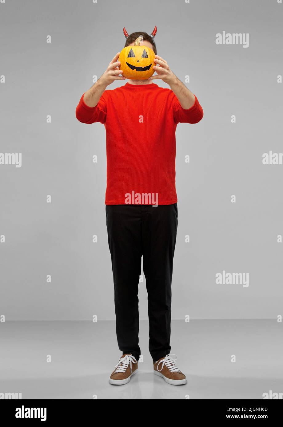 happy man in halloween costume of devil over grey Stock Photo - Alamy