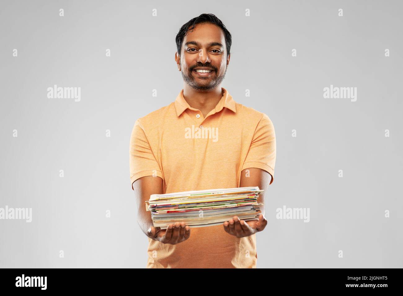 smiling young indian man sorting paper waste Stock Photo - Alamy