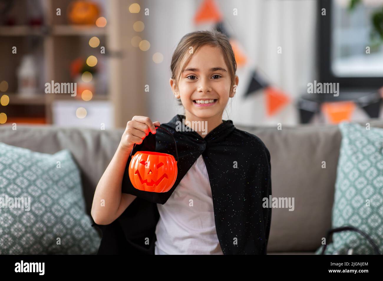 girl in halloween costume with bat cape at home Stock Photo - Alamy