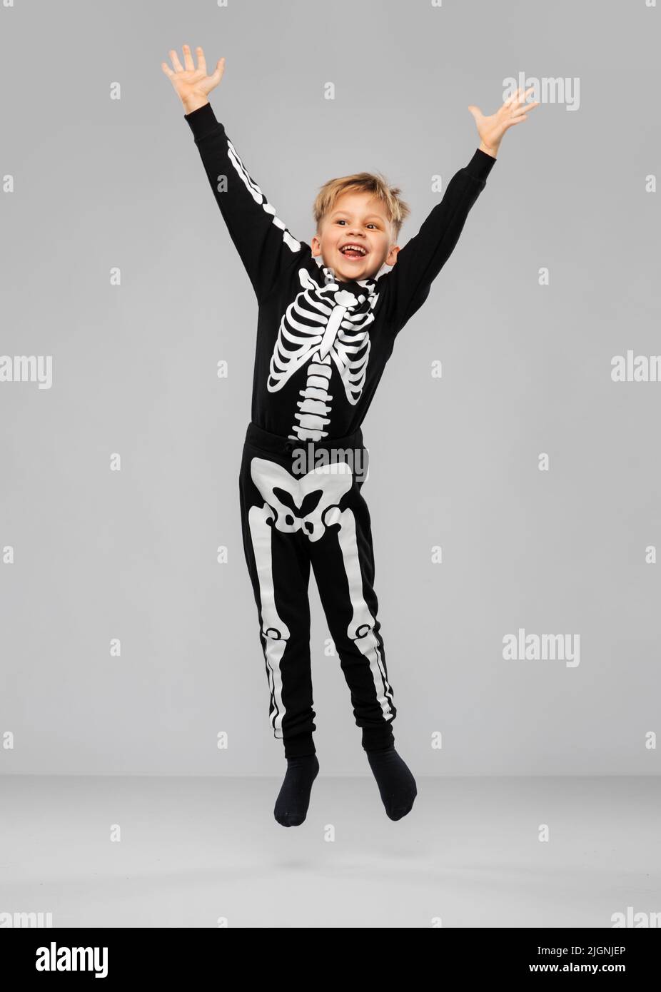 happy boy in halloween costume of skeleton jumping Stock Photo - Alamy