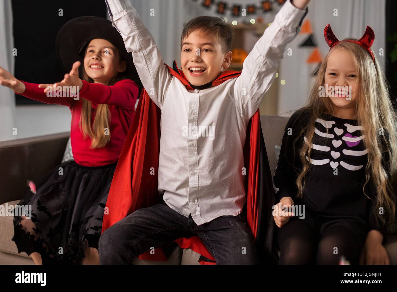 kids in halloween costumes s having fun at home Stock Photo - Alamy
