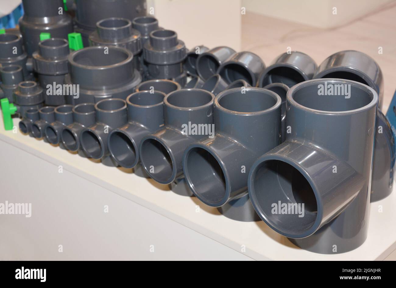 Close up on stack of pvc pipe connectors Stock Photo - Alamy