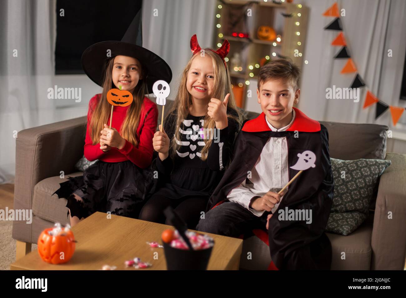kids in halloween costumes having fun at home Stock Photo - Alamy