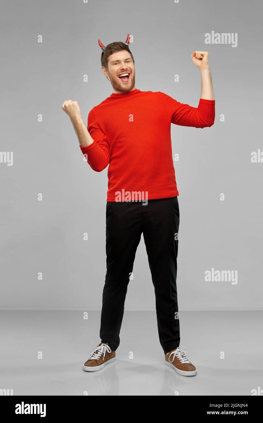 happy man in costume of devil celebrating success Stock Photo - Alamy