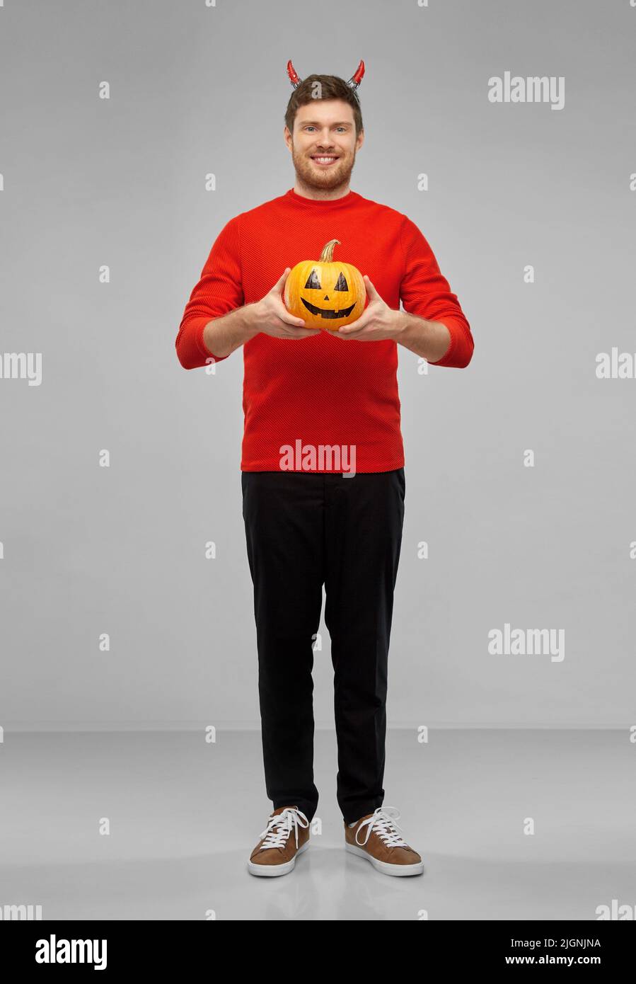 happy man in halloween costume of devil over grey Stock Photo - Alamy