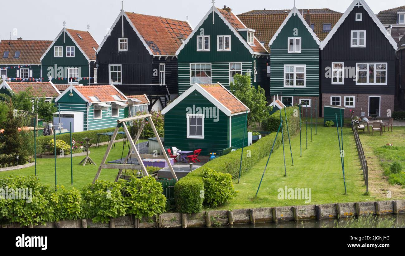 Historic Dutch fishermen village with green wooden houses called Marken ...