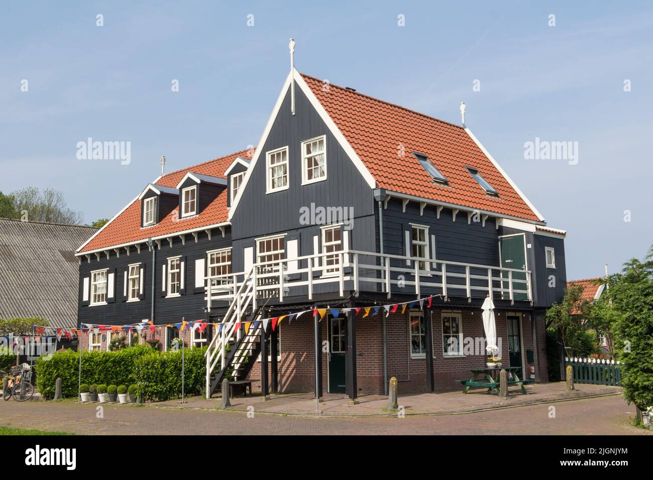 Historic Dutch fishermen village with green wooden houses called Marken ...