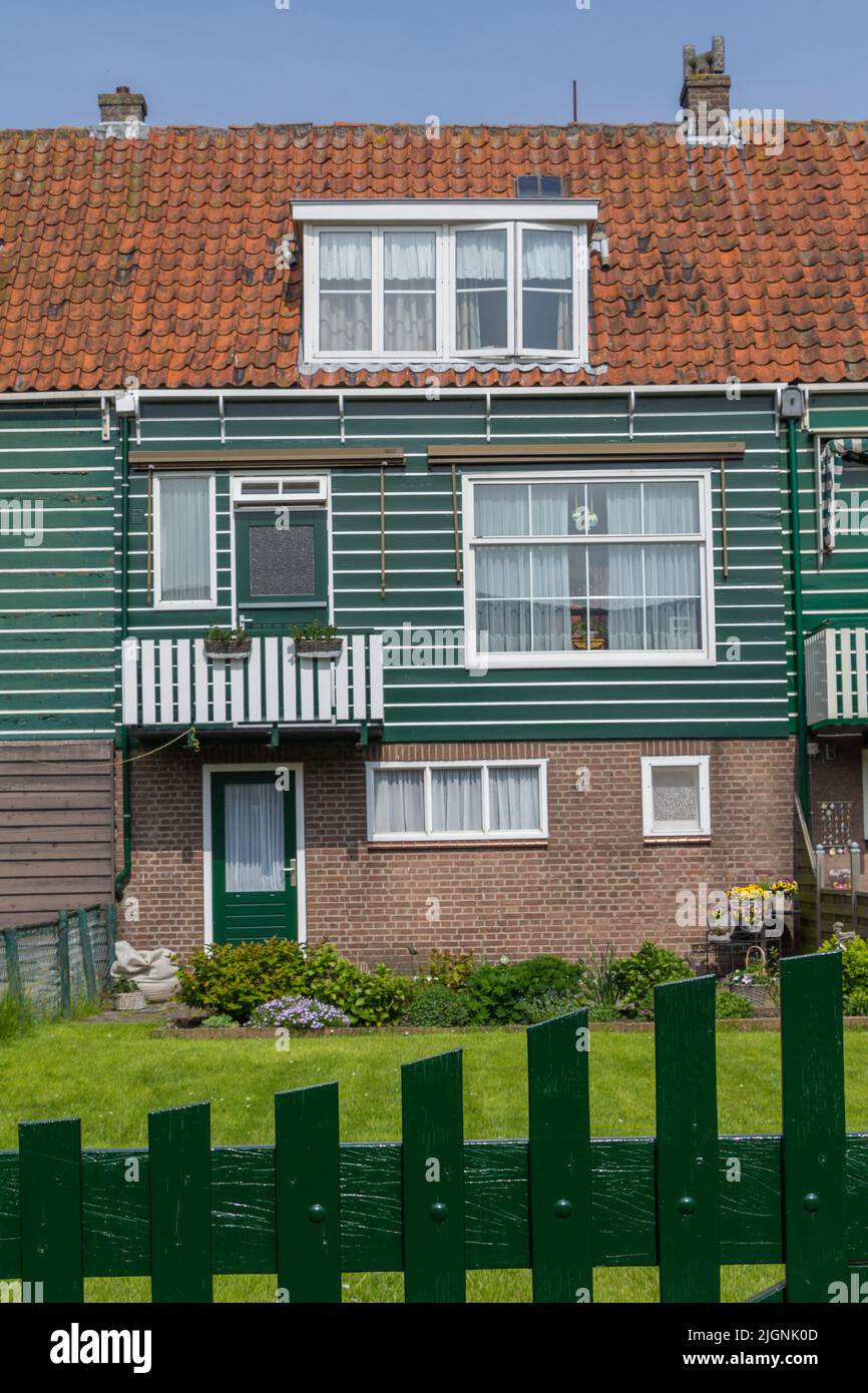 Historic Dutch fishermen village with green wooden houses called Marken ...
