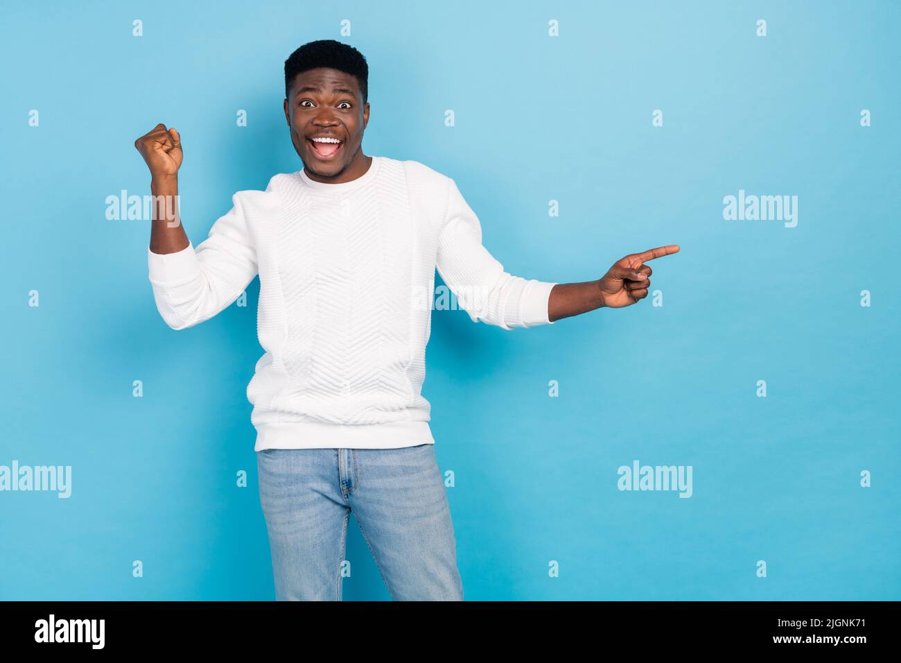 Photo of cheerful overjoyed young man promote product celebrate his ...