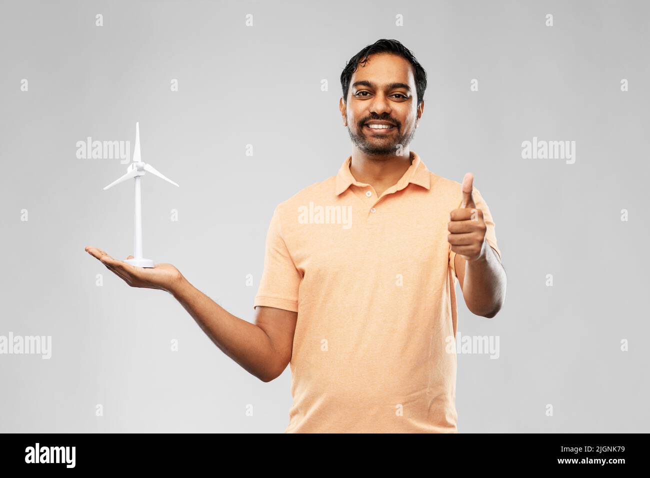 indian man with toy wind turbine showing thumbs up Stock Photo - Alamy