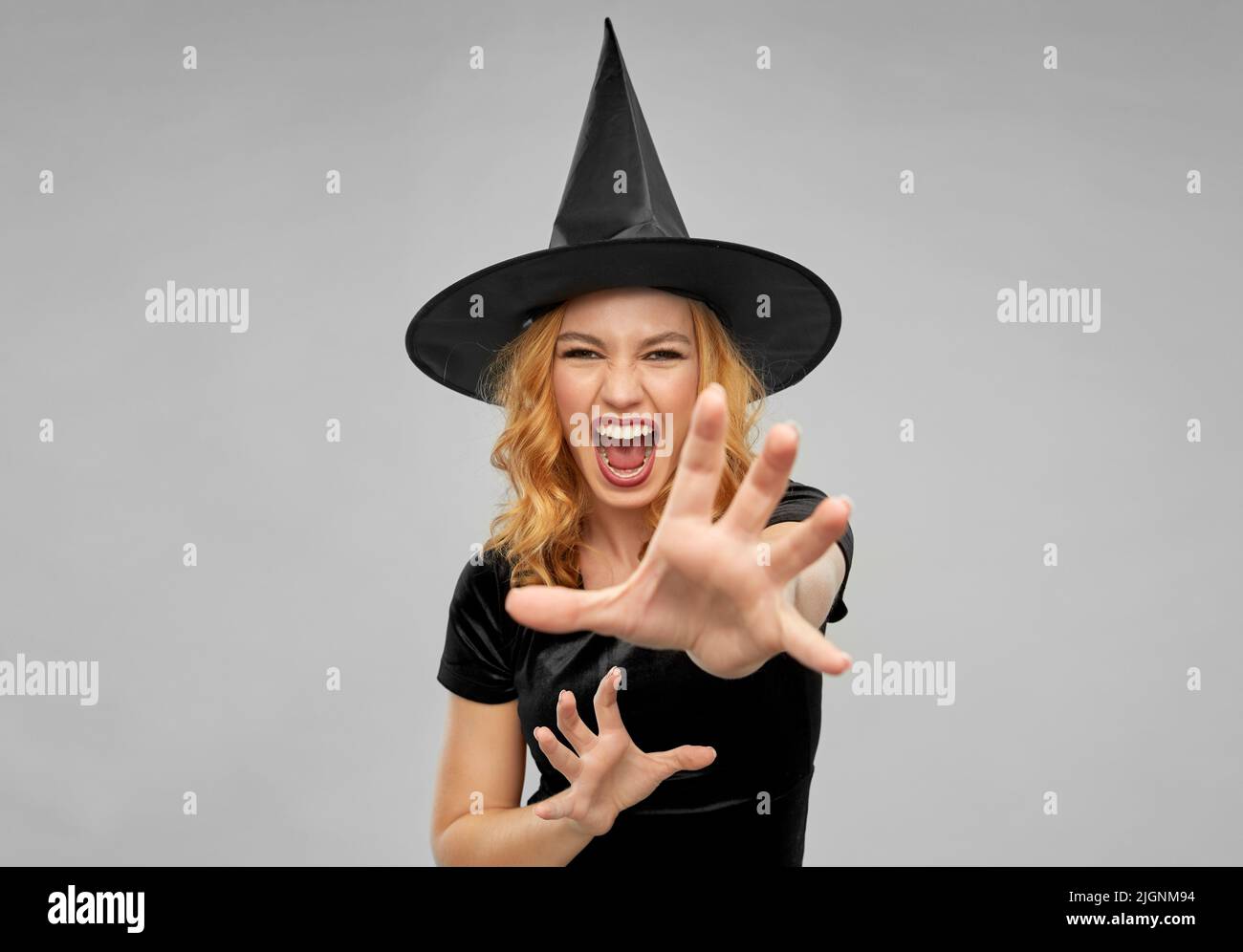 scary woman in black halloween costume of witch Stock Photo - Alamy