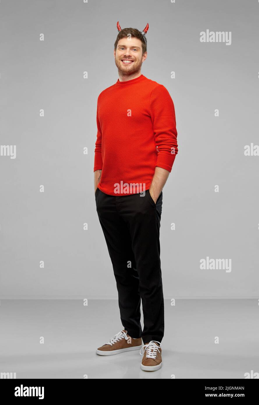 happy man in halloween costume of devil over grey Stock Photo - Alamy