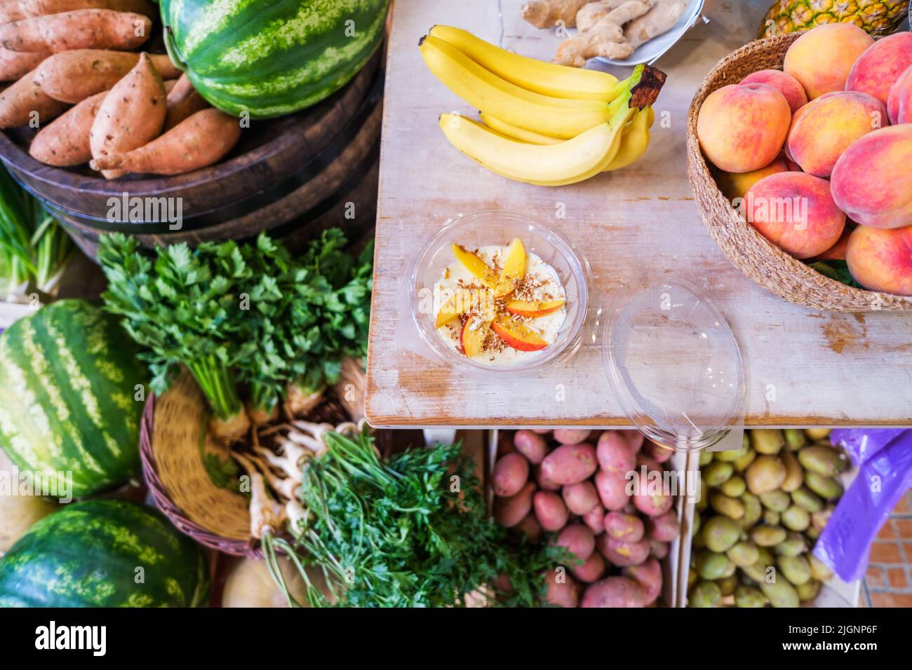 Healthy fruit shake on table with lot of fruits and vegetables in store ...