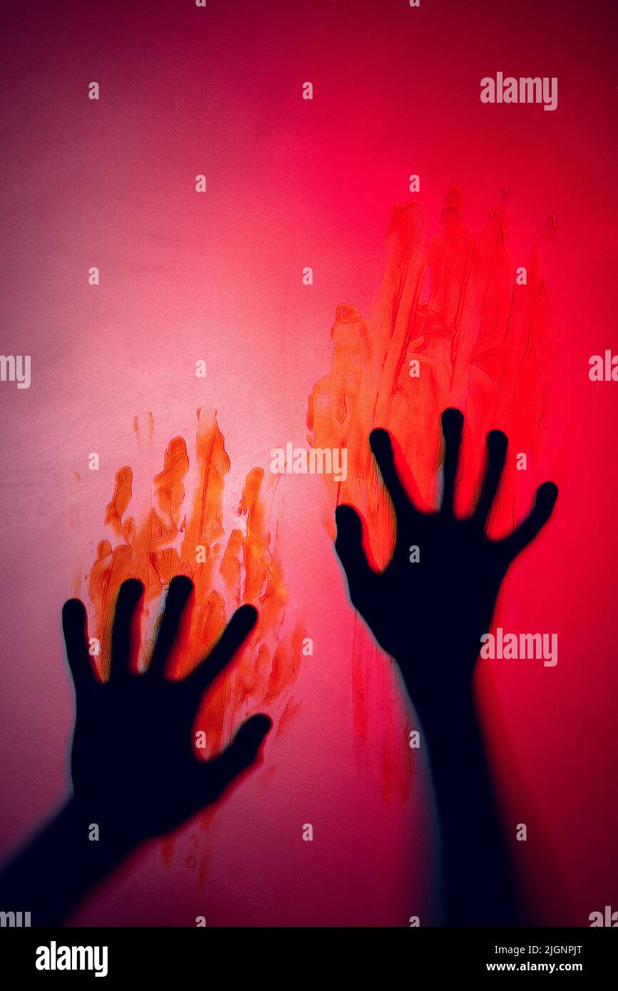 Composition of shape of black hands with blood stains on red background ...