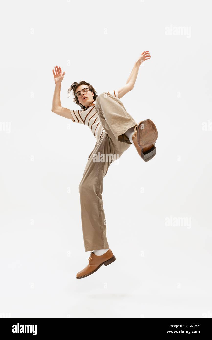 Portrait of expressive young man in vintage outfit dancing, posing ...