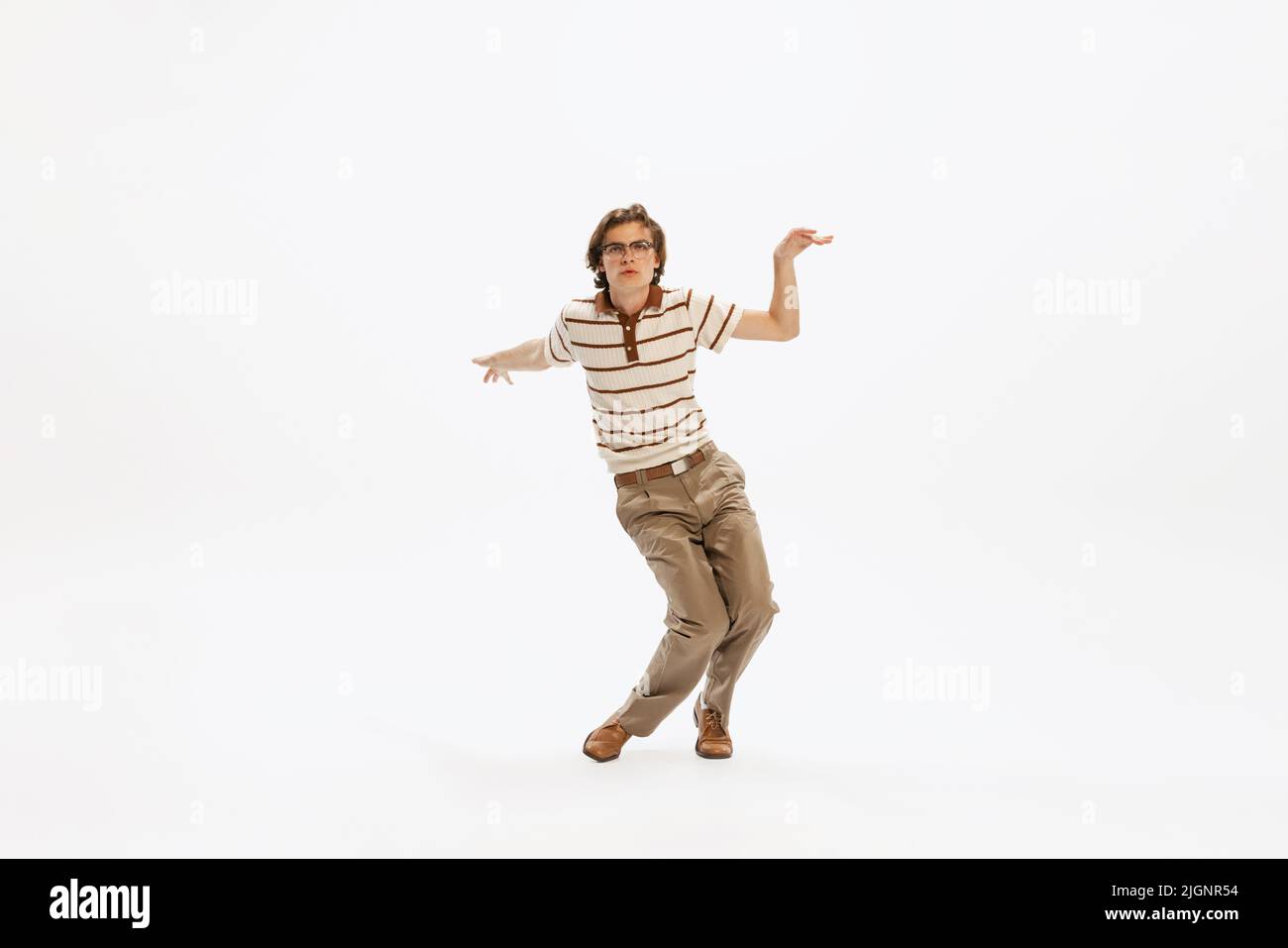 Portrait of expressive young man in vintage outfit dancing, posing ...