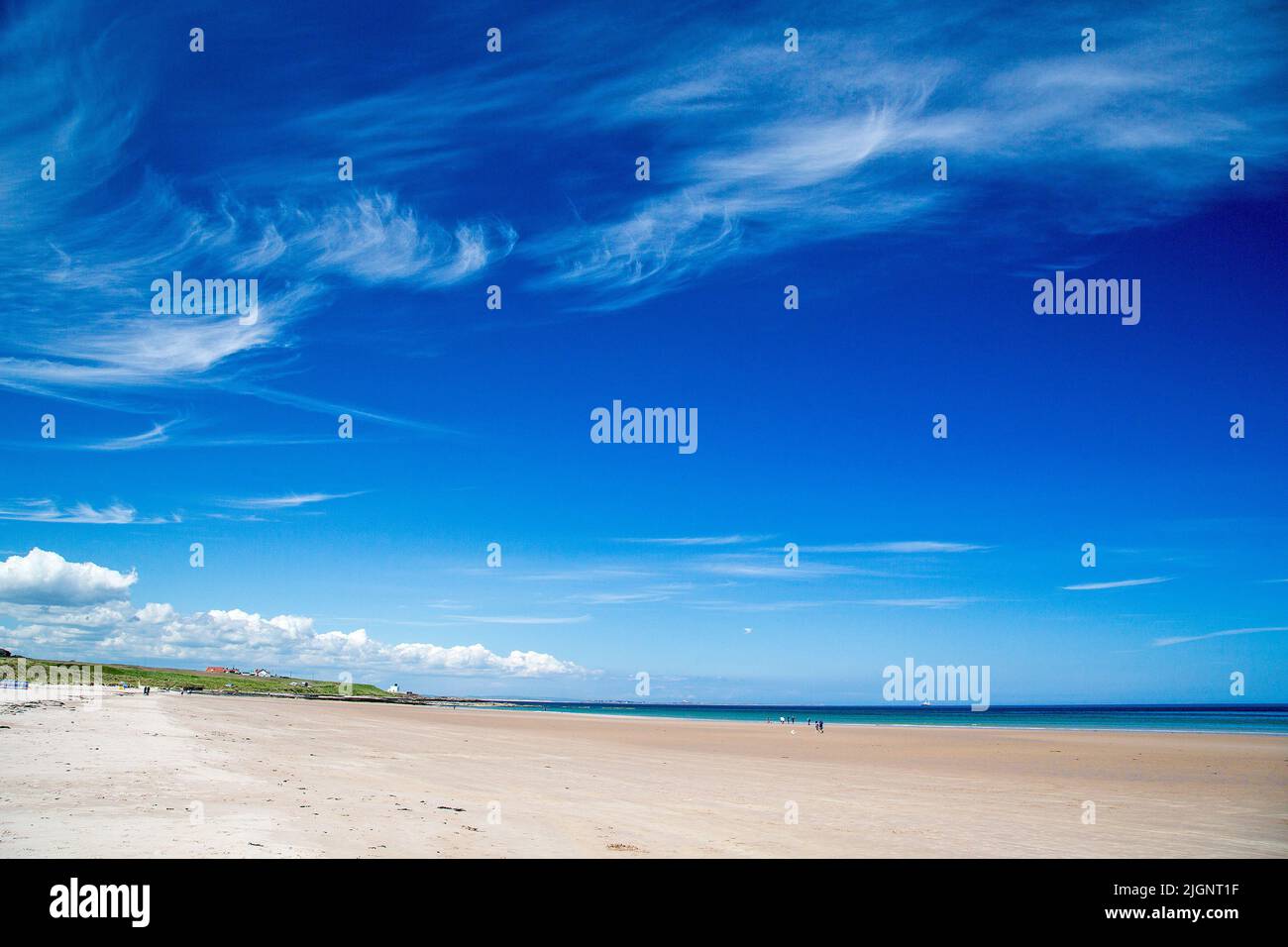 The beach at Bamburgh Castle, Bamburgh, Northumberland, UK ,on a bright ...