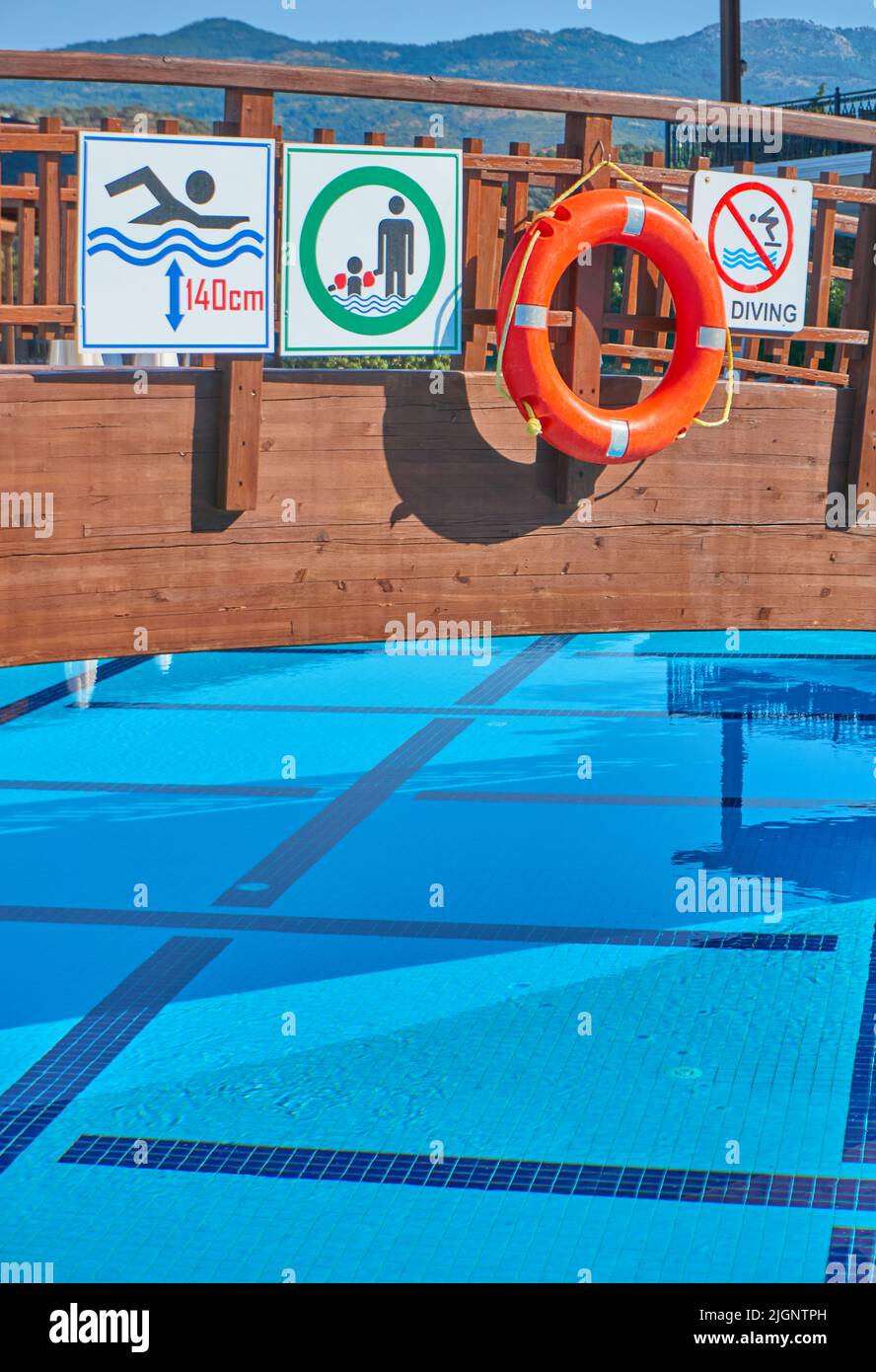 Lifebuoy, pool dept and no diving signs next to each other Stock Photo ...