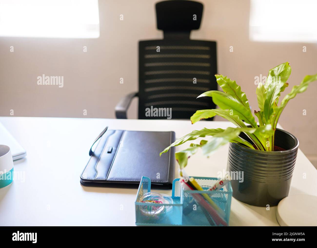 An empty desk in an executive's office with neat organised workspace ...