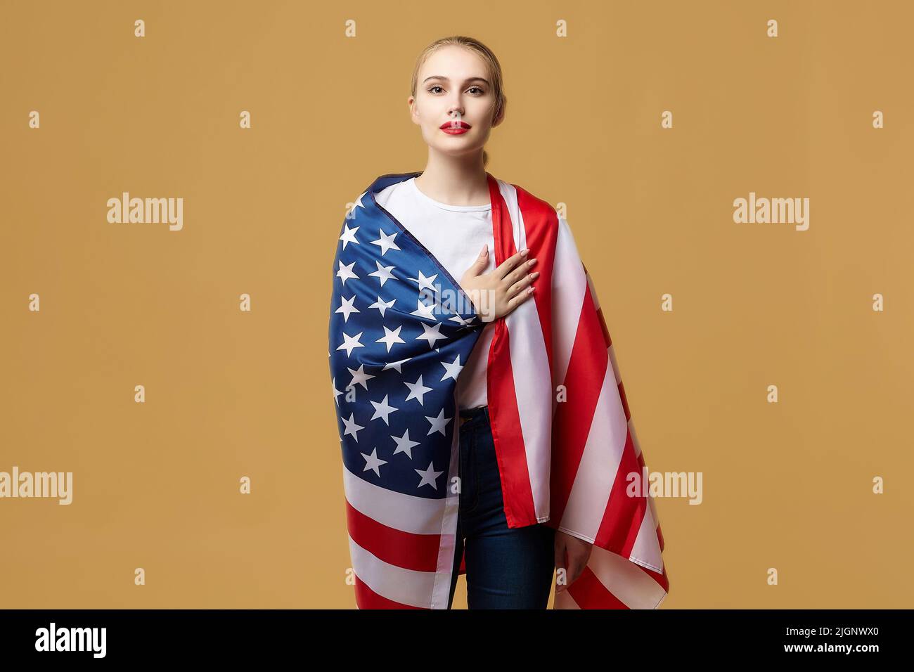 attractive blonde proudly poses with an American flag. photo shoot in ...