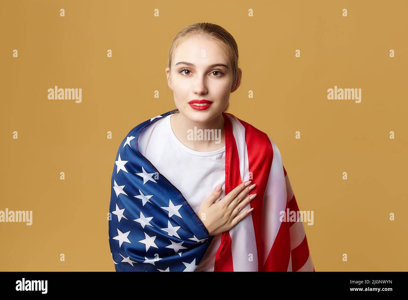 attractive blonde proudly poses with an American flag. photo shoot in ...