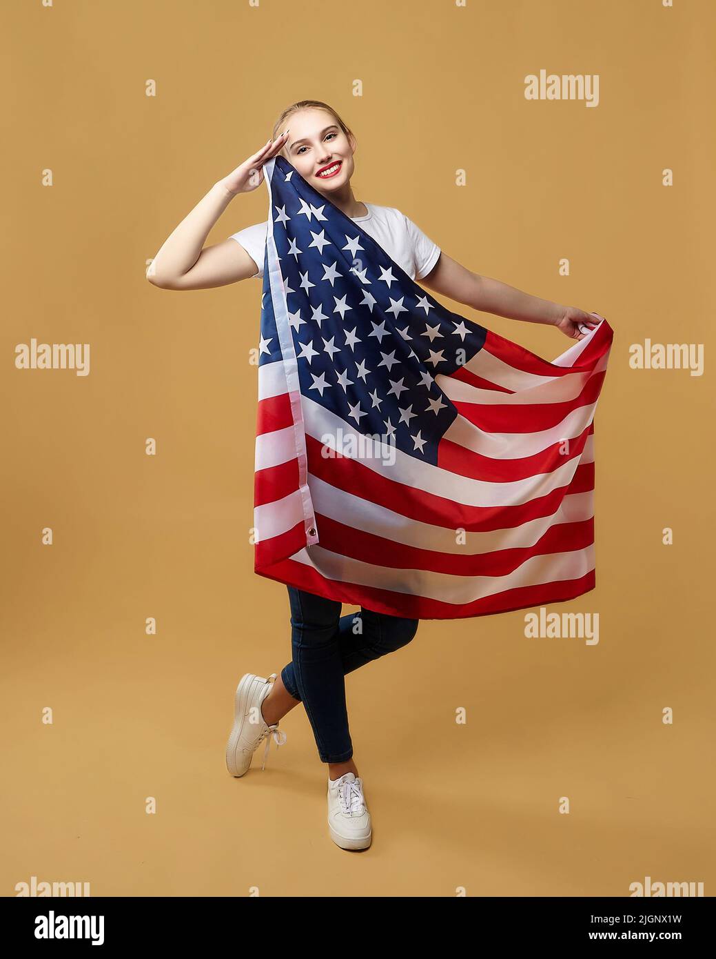 attractive blonde proudly poses with an American flag. photo shoot in ...