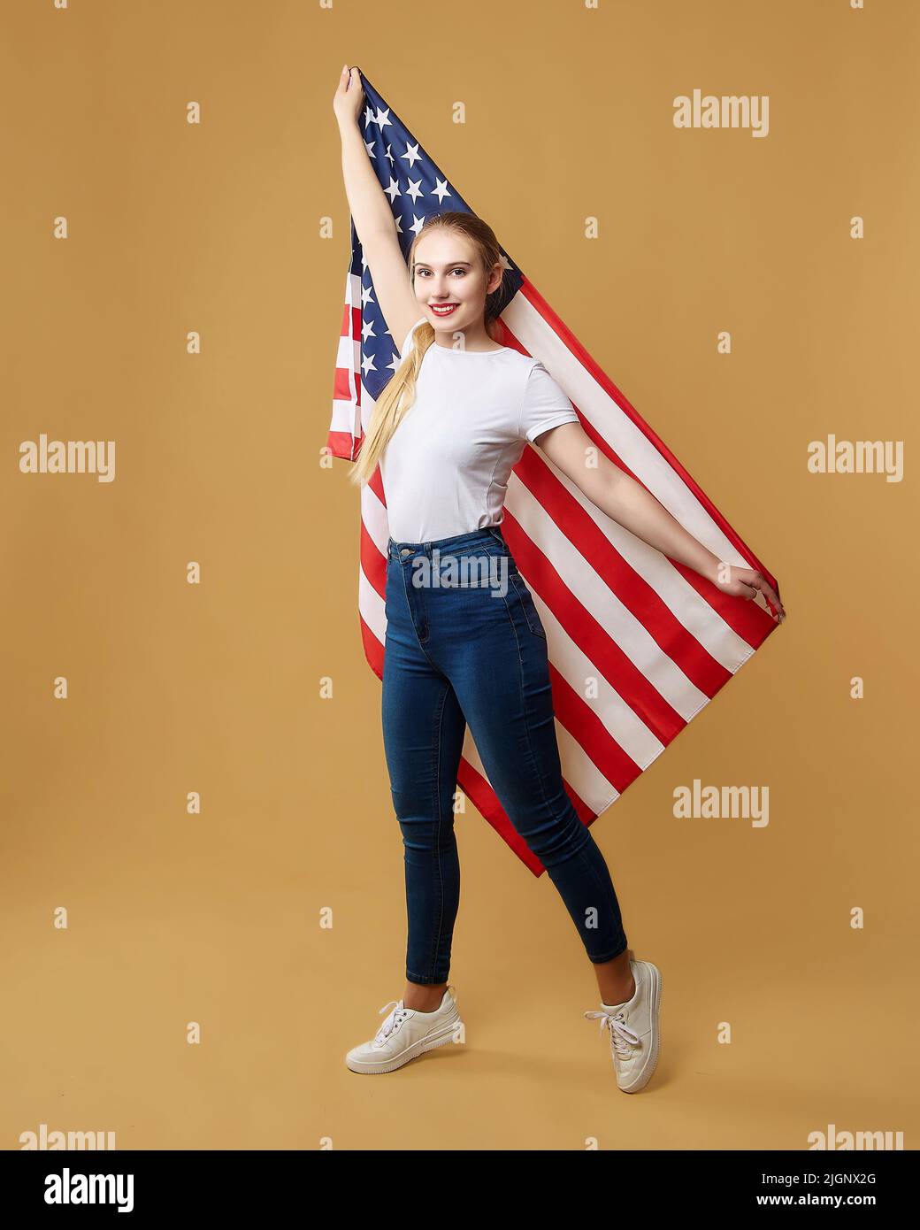 attractive blonde proudly poses with an American flag. photo shoot in ...