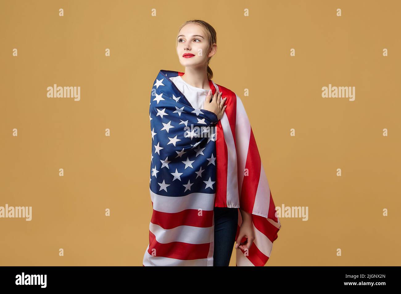 attractive blonde proudly poses with an American flag. photo shoot in ...