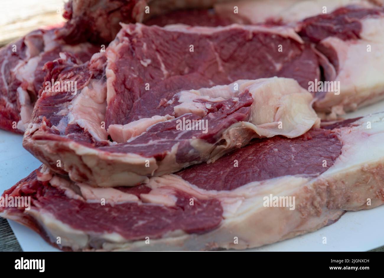 Selective focus of raw fresh steaks with an appetizing layer of fat ...