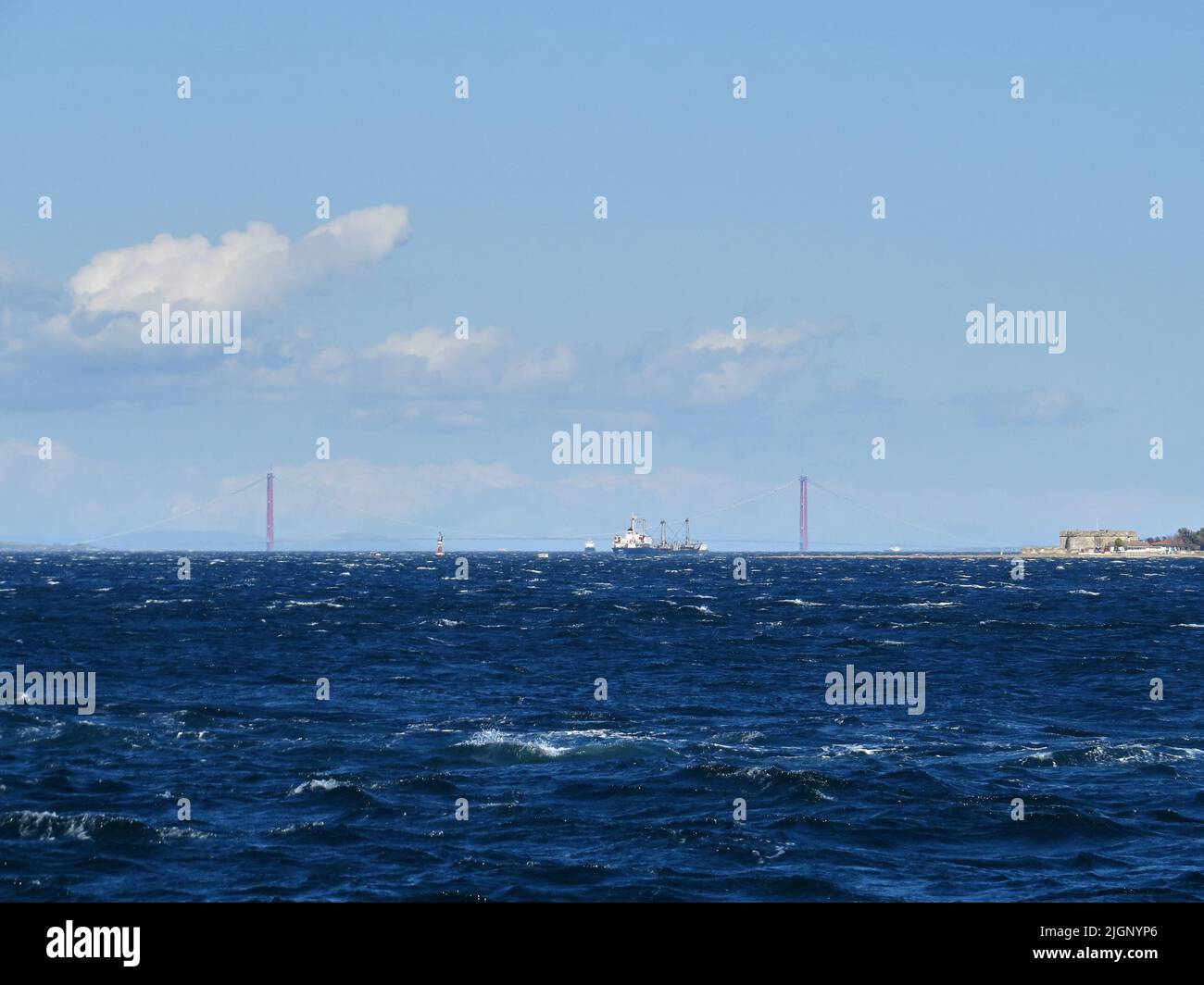 Cargo ship crossing the strait , 1915 Canakkale Bridge in background ...