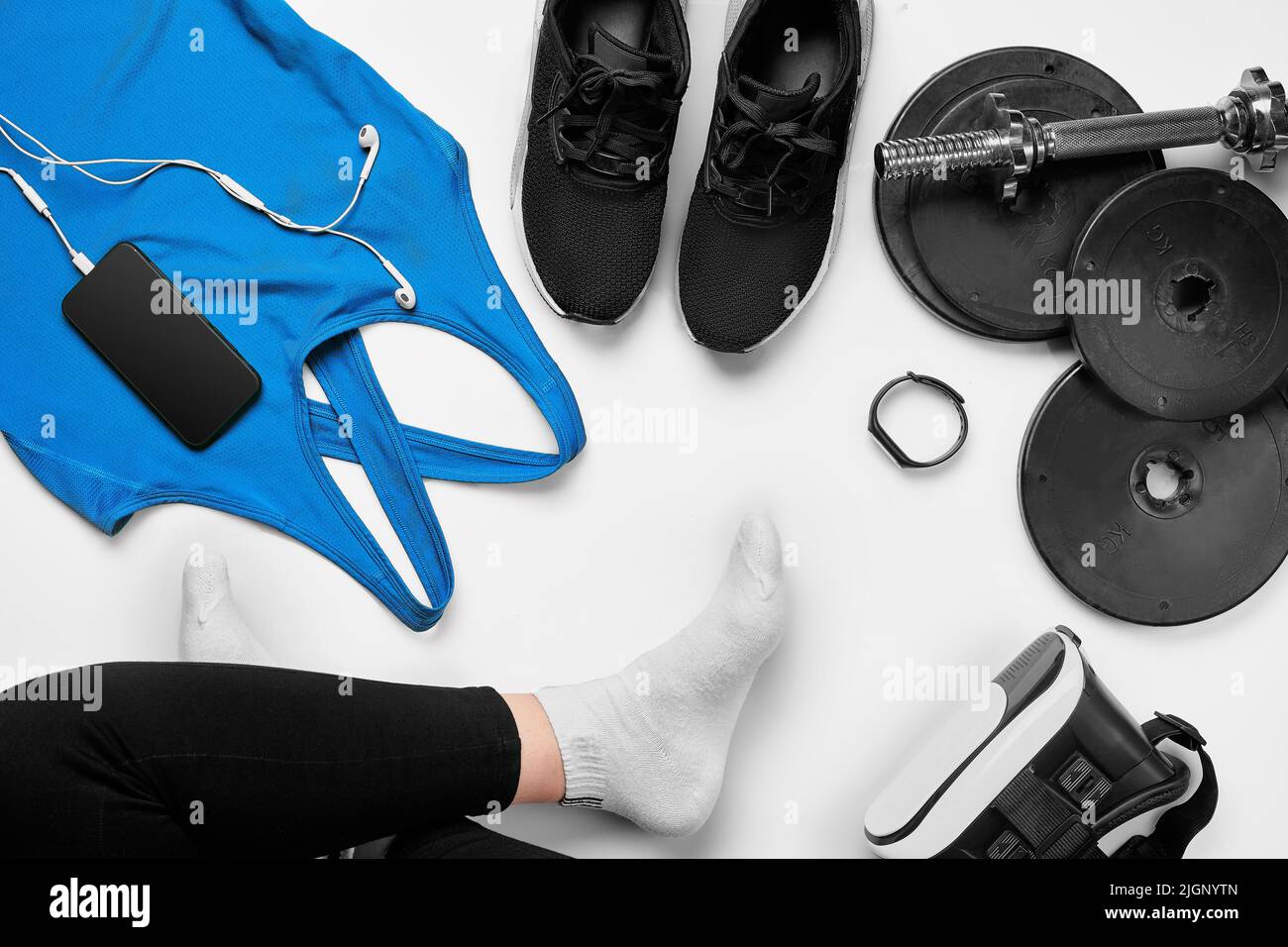 Flat lay gym equipment such as dumbbells, bottle of waters, smartphone ...