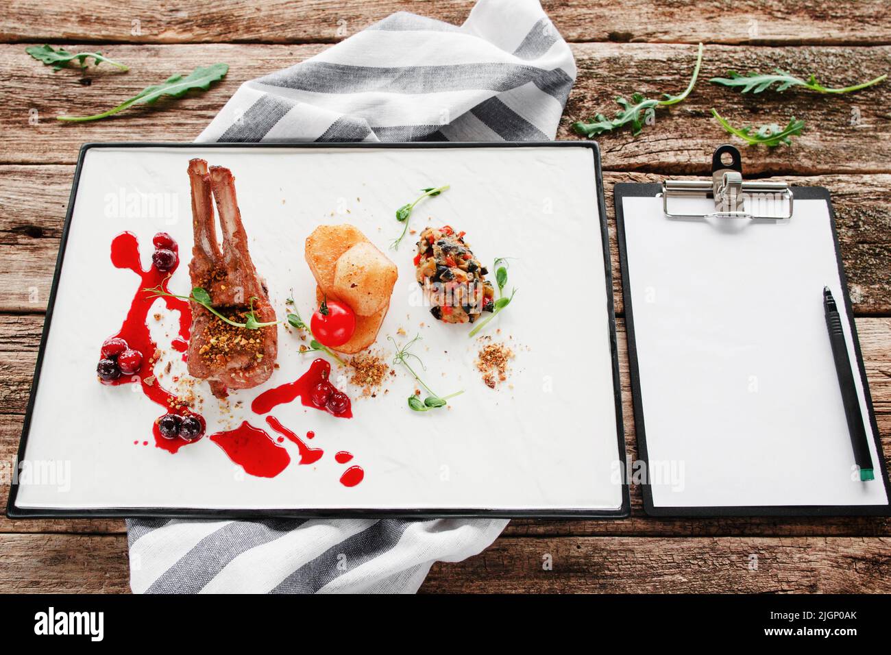 Expensive restaurant meal with blank notepad Stock Photo - Alamy