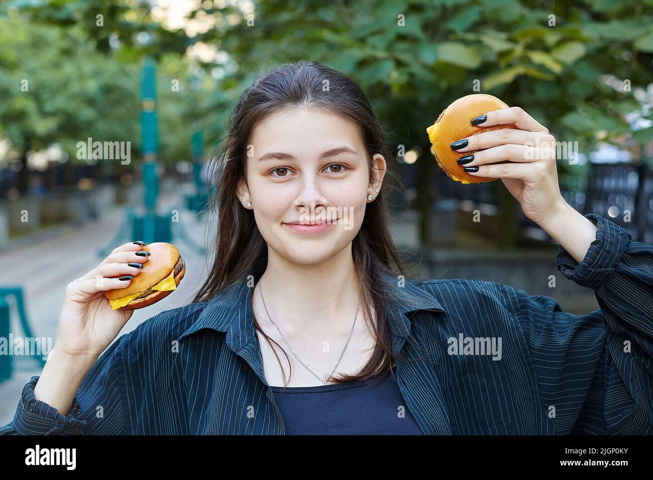 Holding a burger two hands hi-res stock photography and images - Alamy