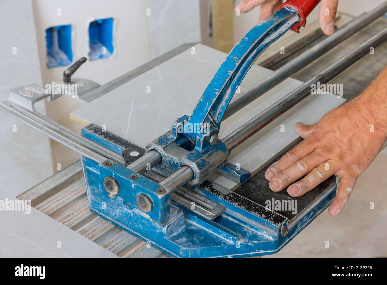 In construction worker cutting is using manual tools equipment to lay ...